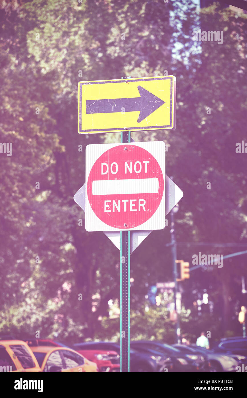 Do not enter and direction arrow street signs, color toned picture ...