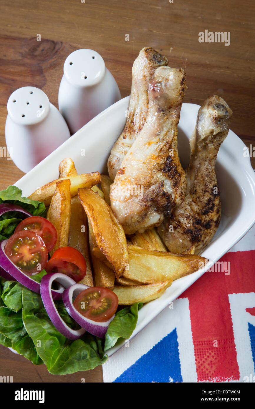 English pub meal of Roast Chicken drumsticks with chips/fries and a ...