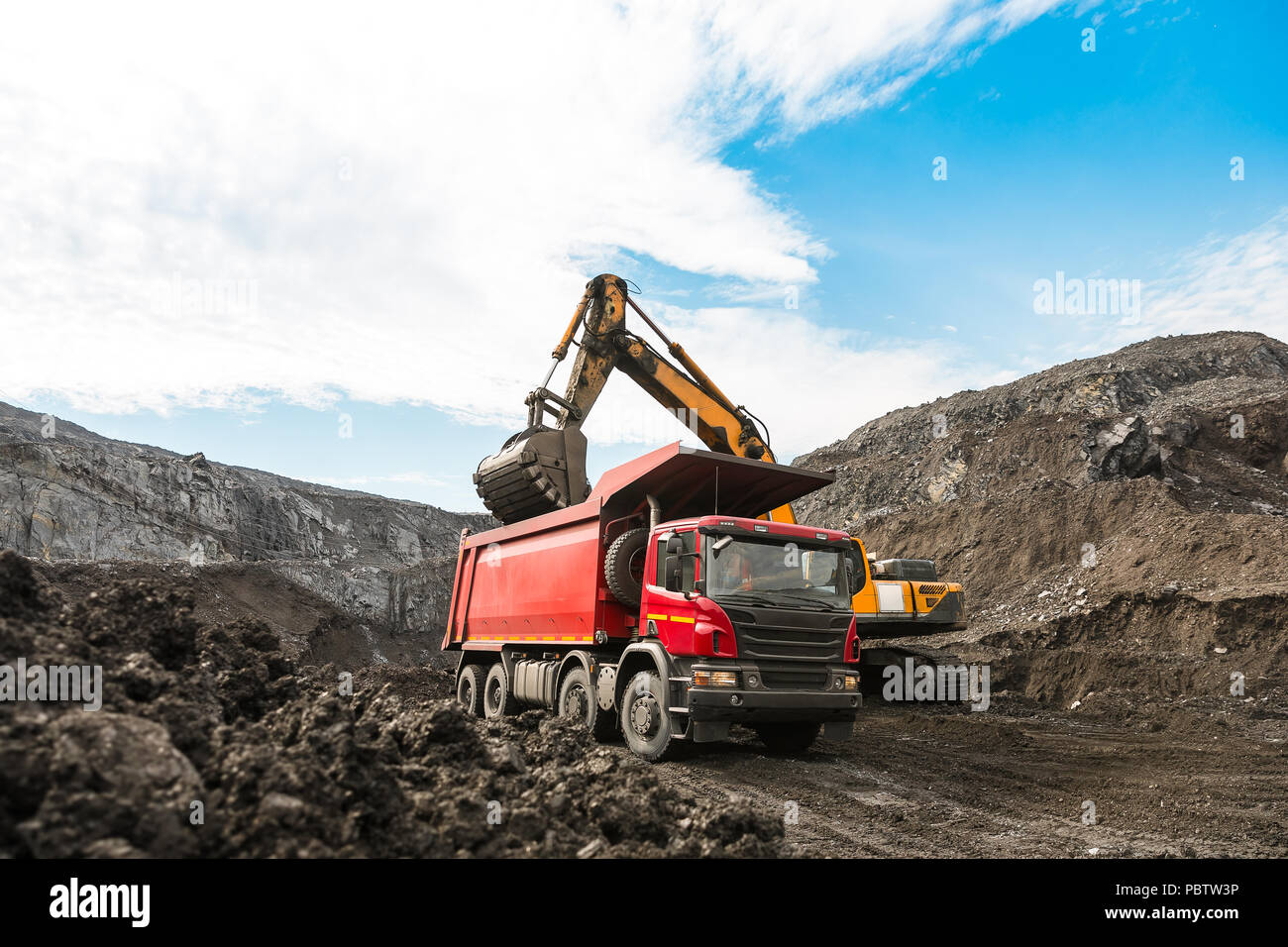 Large quarry dump truck. Loading the rock in dumper. Loading coal into ...