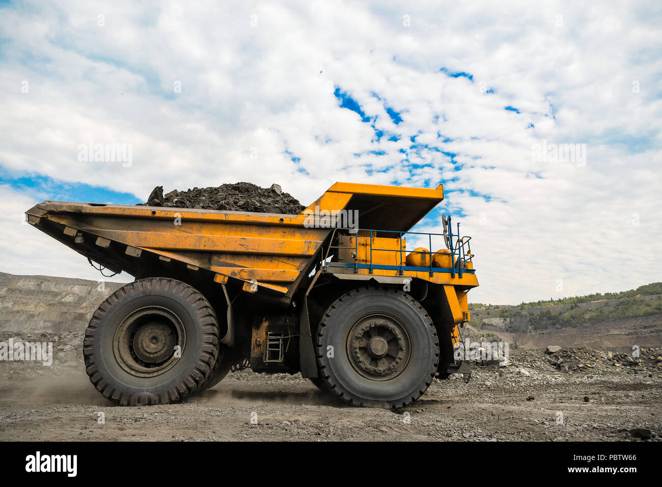 Large quarry dump truck. Loading the rock in dumper. Loading coal into body truck. Production ...