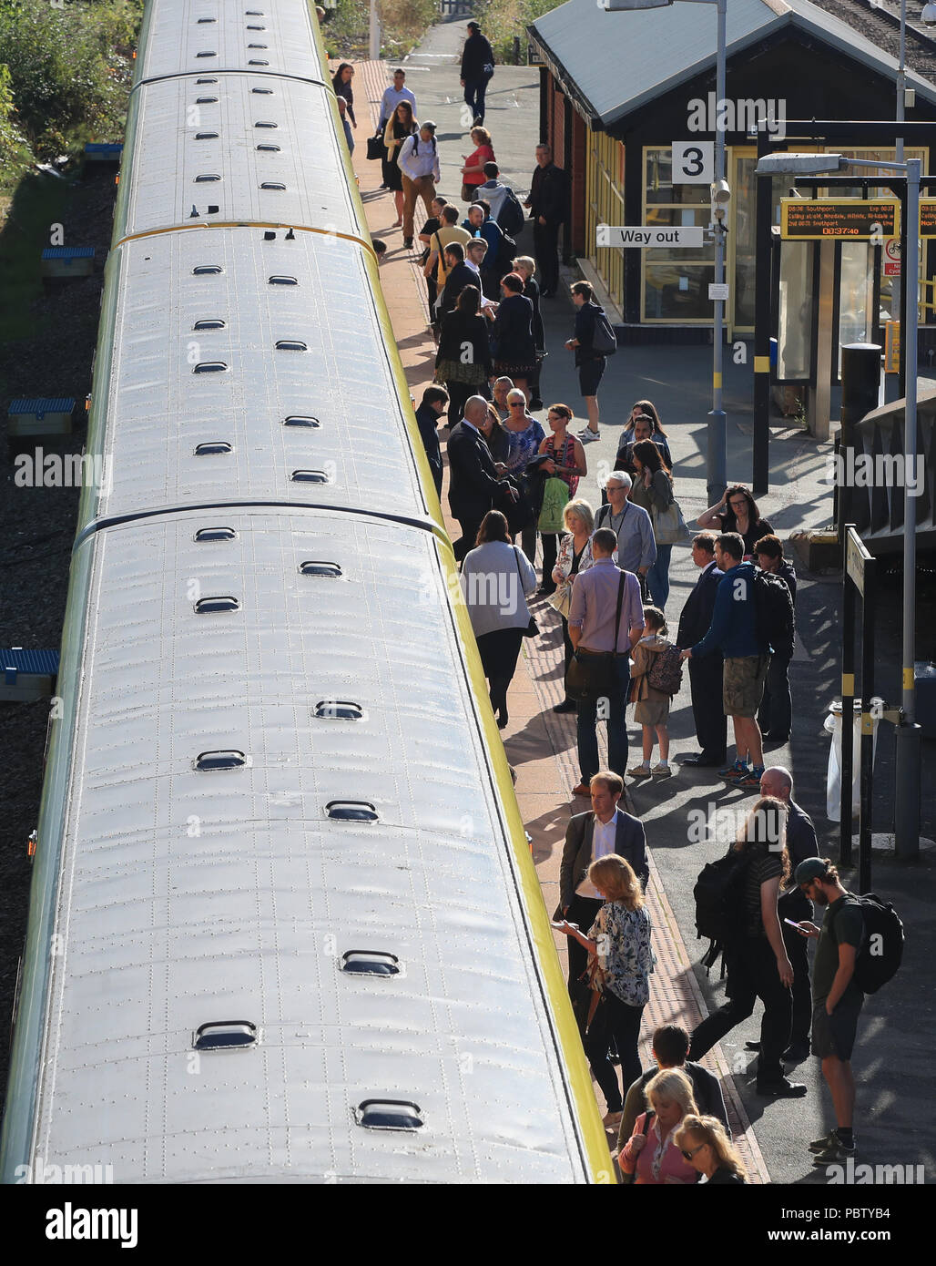 Passengers board a Merseyrail train at Hunts Cross Station in Liverpool ...