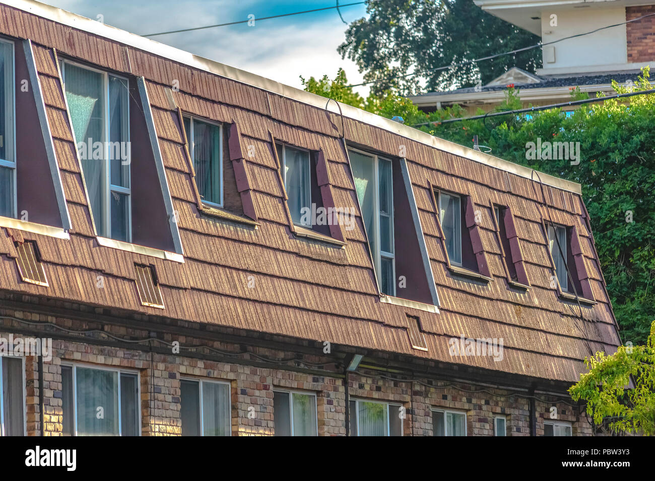 Residential building with windows on roof Stock Photo - Alamy