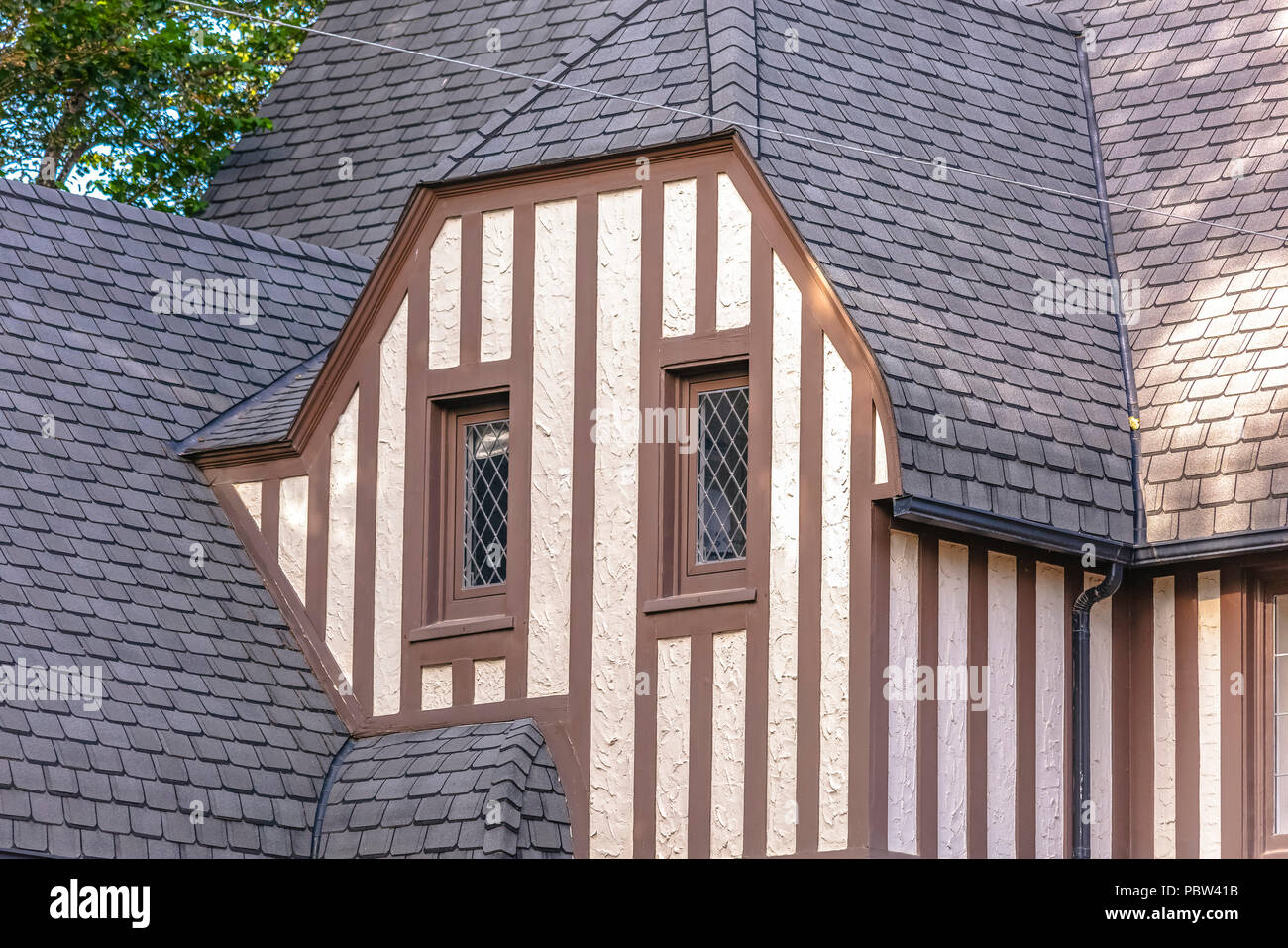 Small windows on striped residential building Stock Photo - Alamy