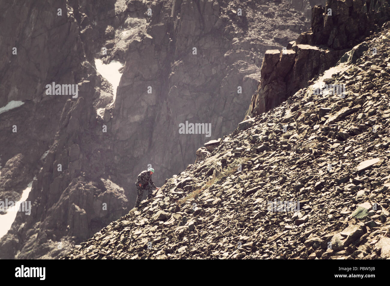 man climbing steep mountain. Good image for adventure, struggle and ...