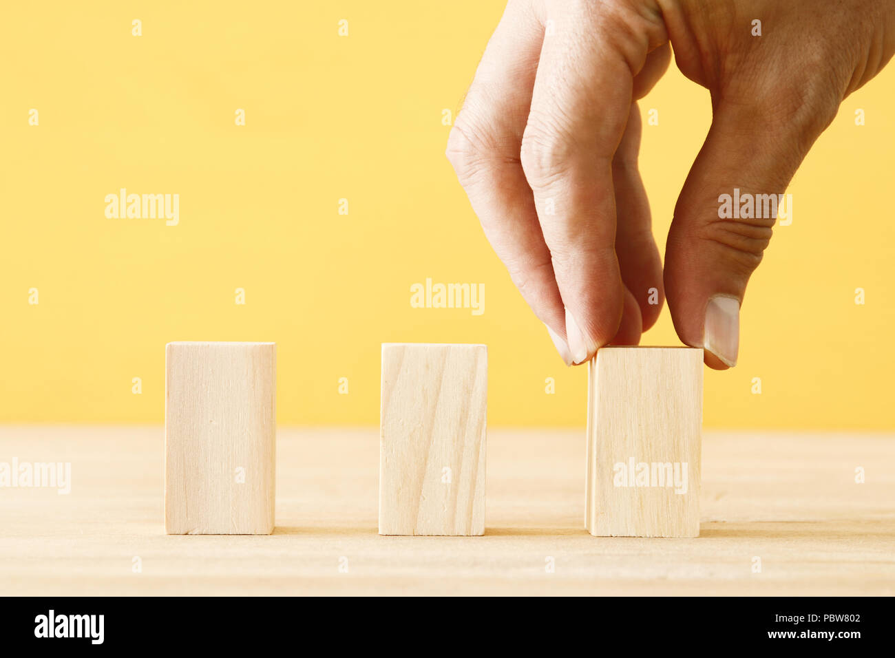 man hand picking a blank wooden block. empty blocks for mock up Stock ...