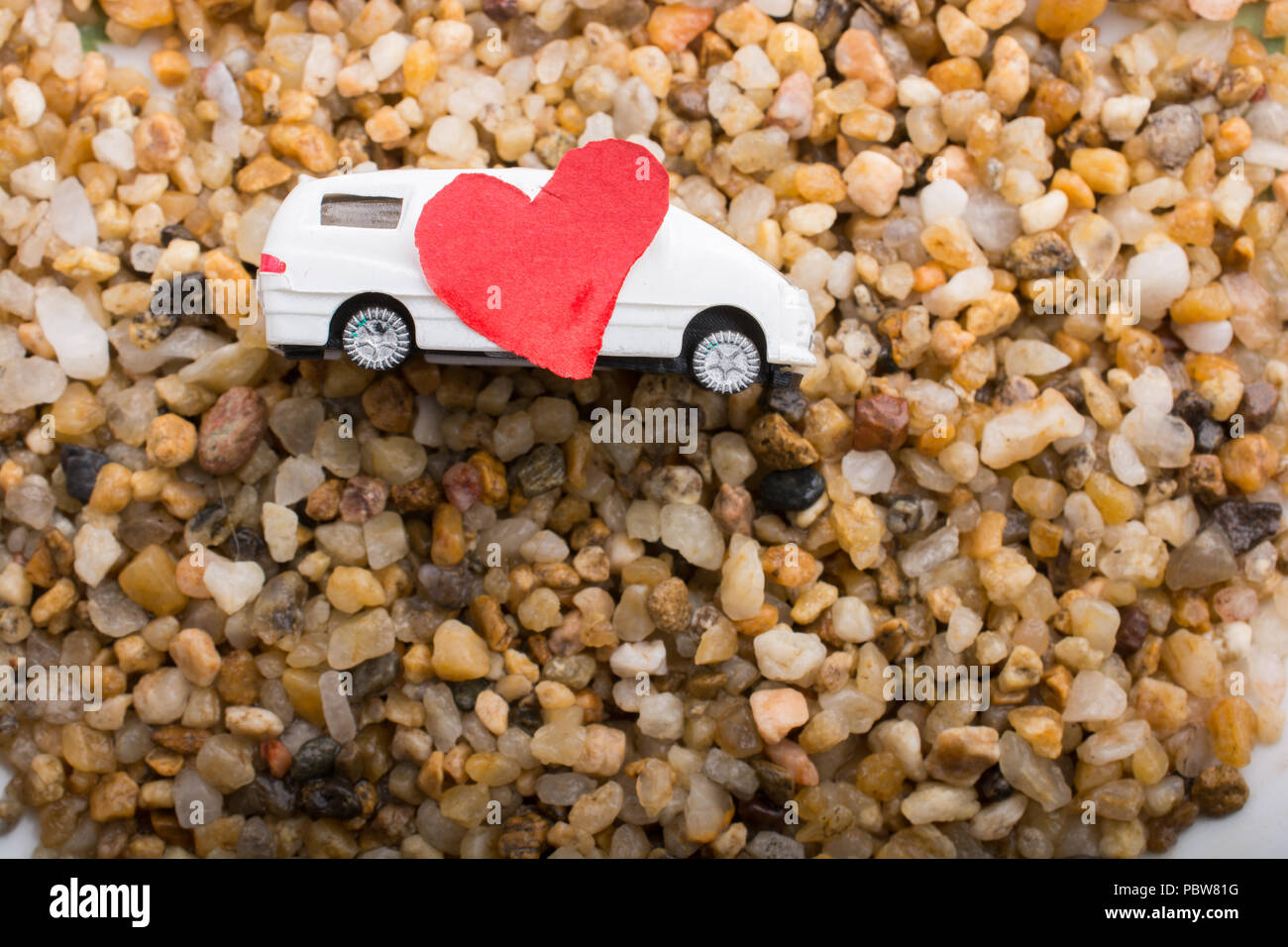 Love concept with model car and heart shaped papers Stock Photo - Alamy