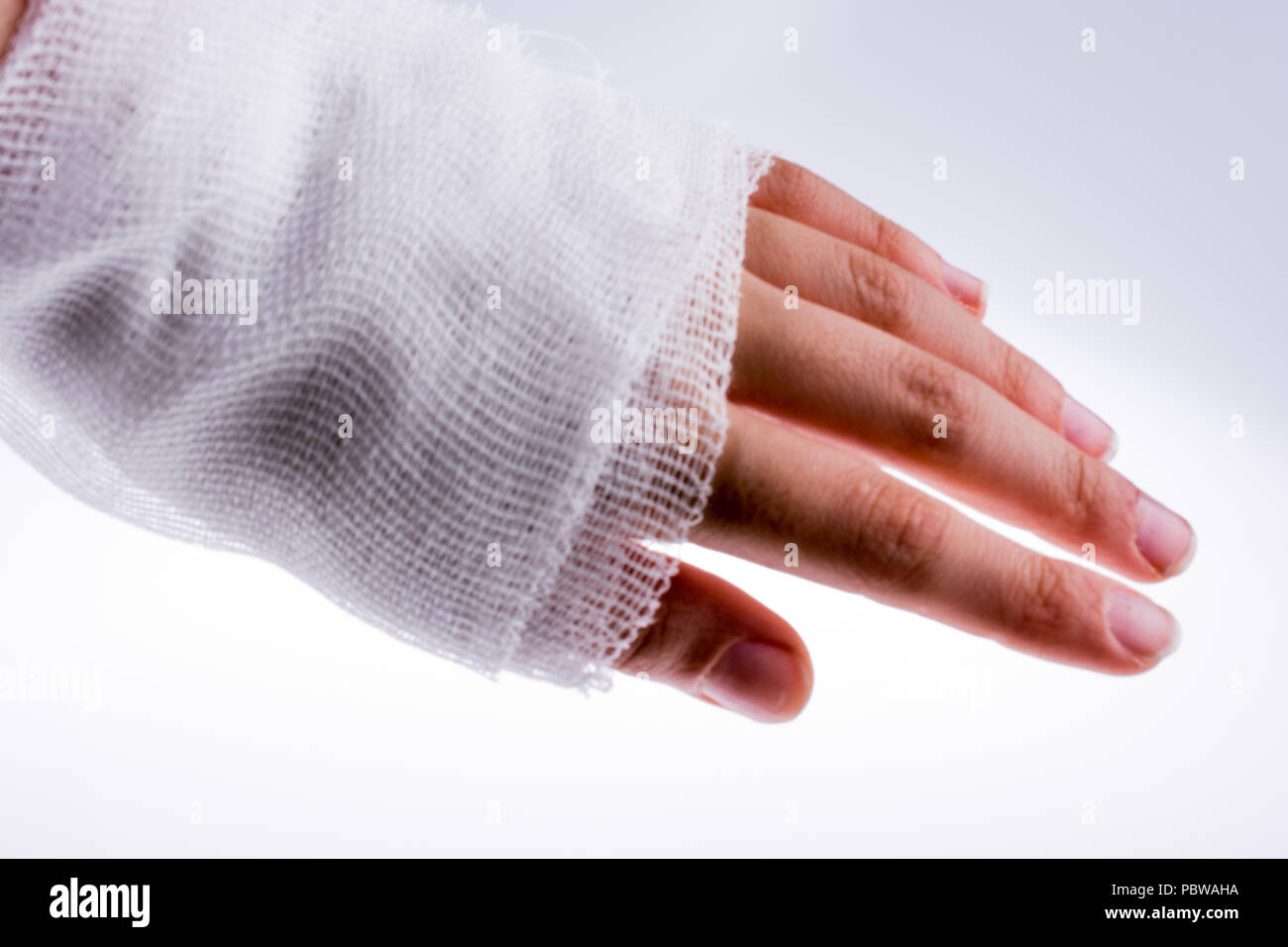 hand wrapped in white bandage on a white background Stock Photo - Alamy