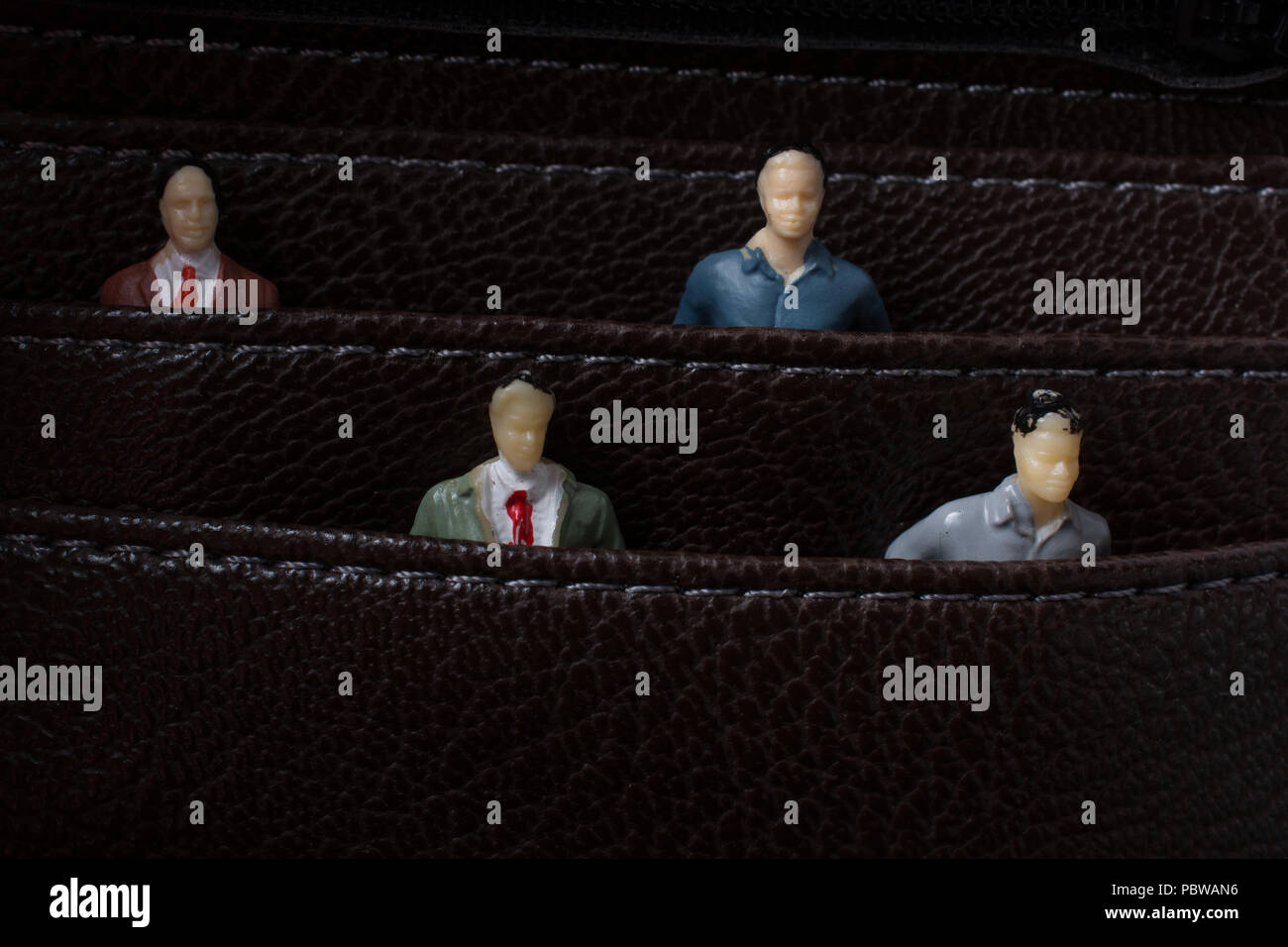 Tiny figurine of group of men miniature model in pockets Stock Photo ...