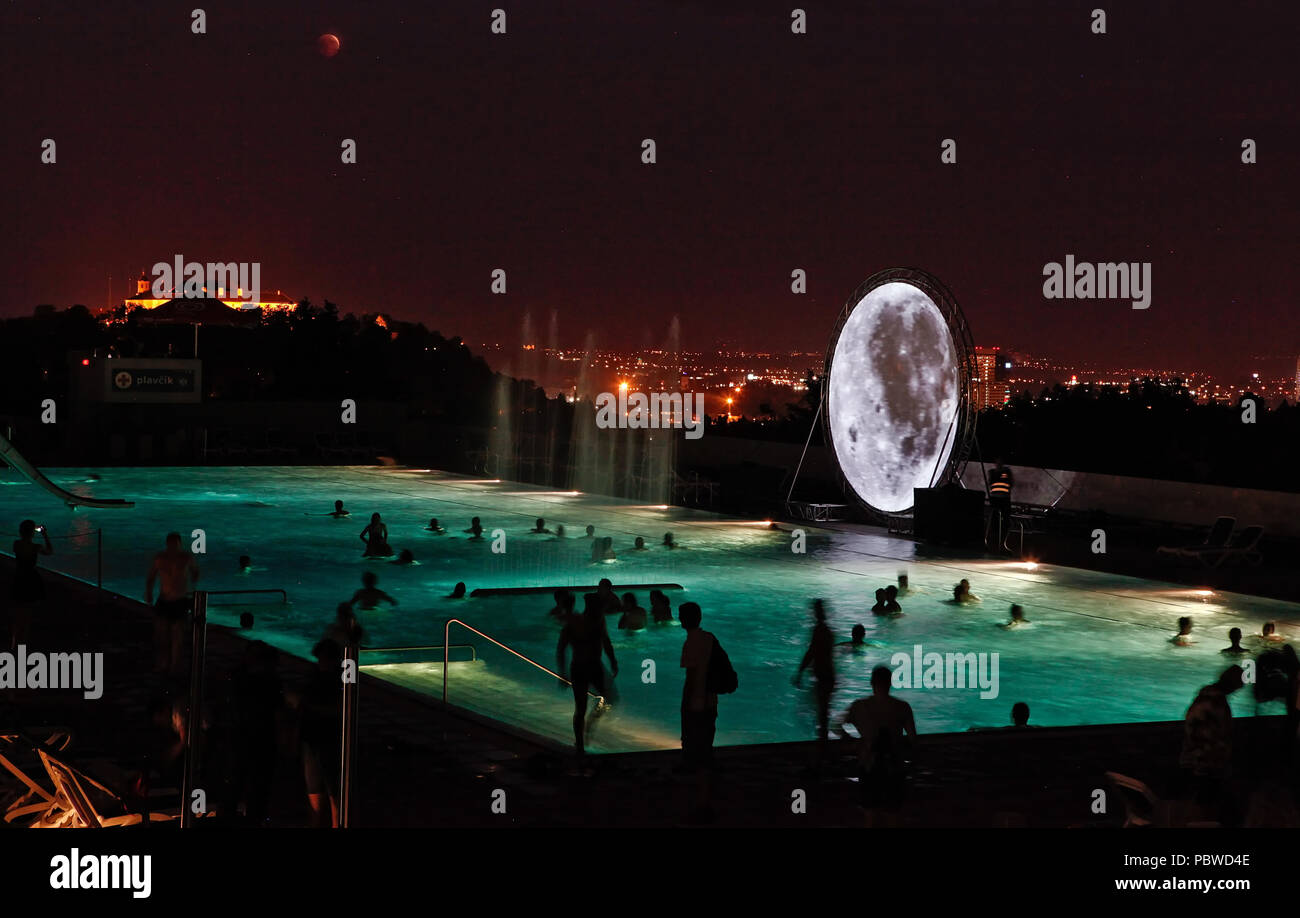 People enjoy a photographic simulation of a total lunar eclipse and ...