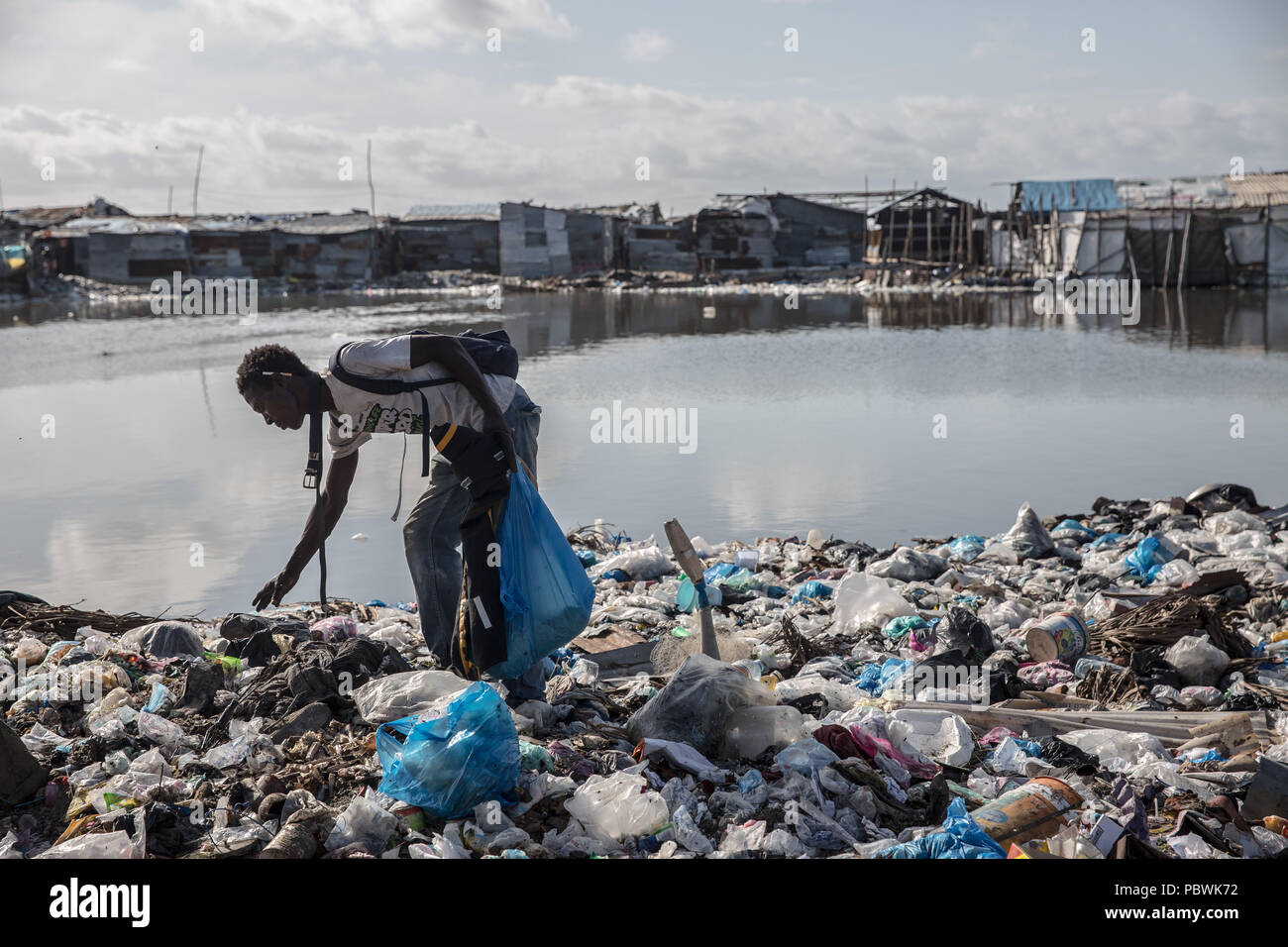 Monrovia, Liberia. 30th May, 2018. A man sifts through rubbish looking ...