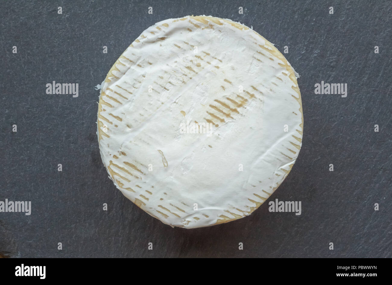 Camembert cheese isolated on black slate cheese board - Top view photo ...