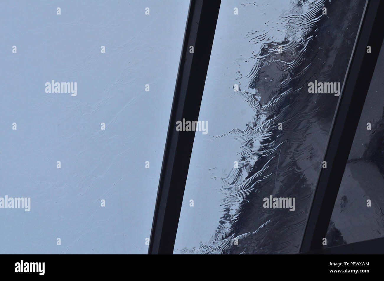 A heavy rain rains on the window, outside the window you can see the ...