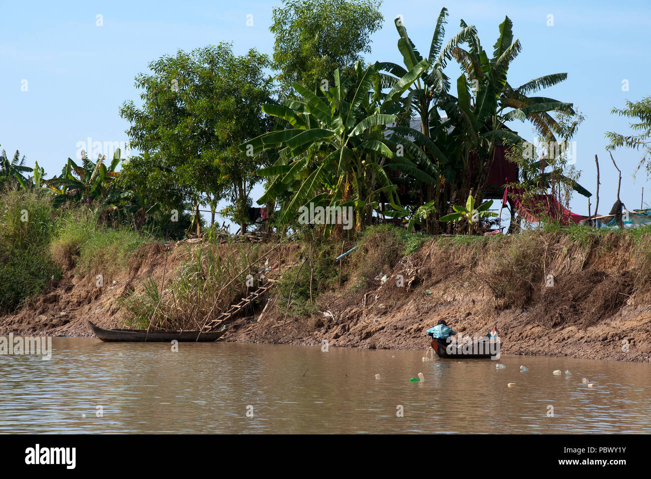 Sangker River, Battambang Cambodia, fisherman in wooden boat in late ...