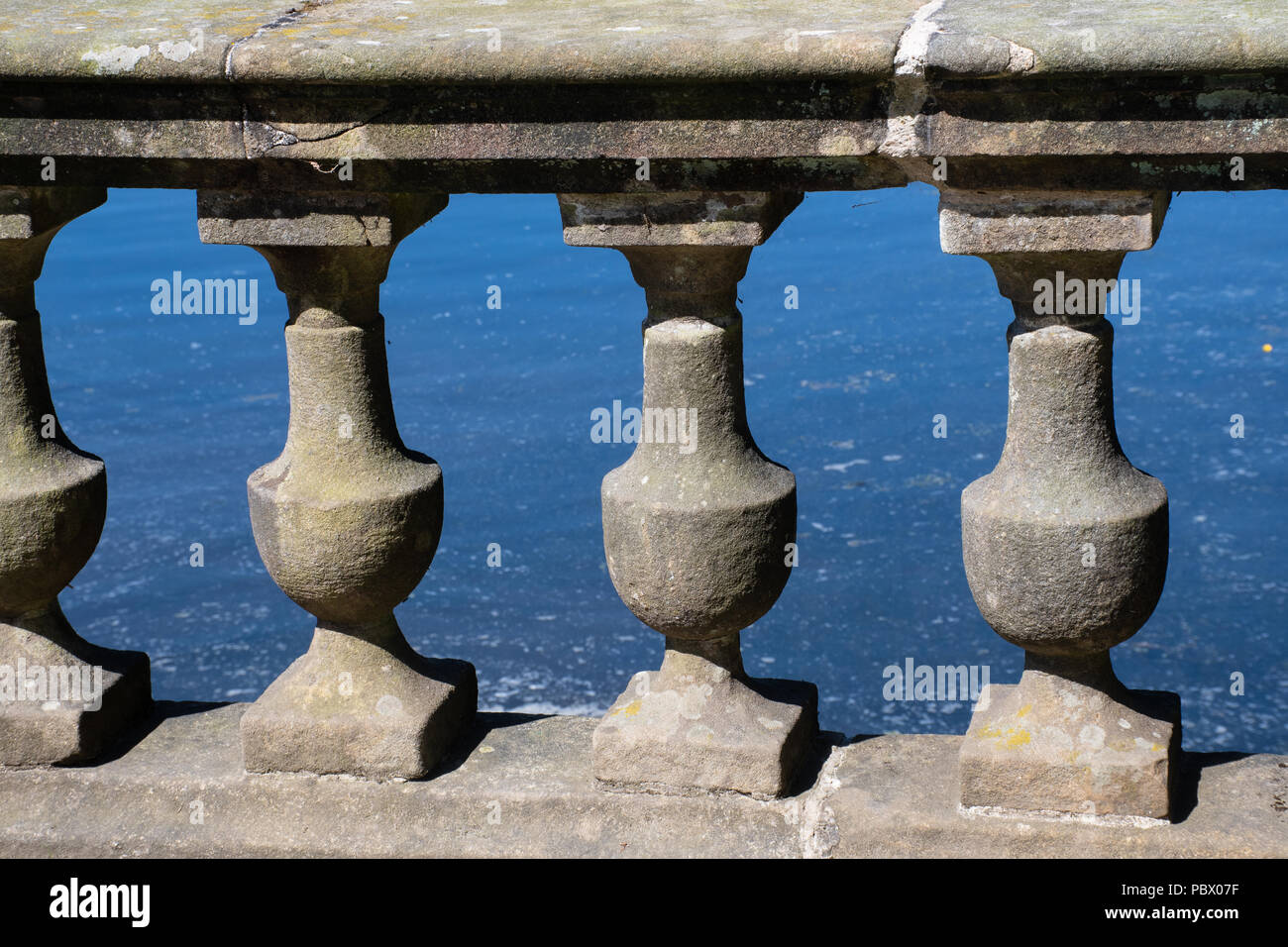 Classical stone railings with pond in background Stock Photo - Alamy