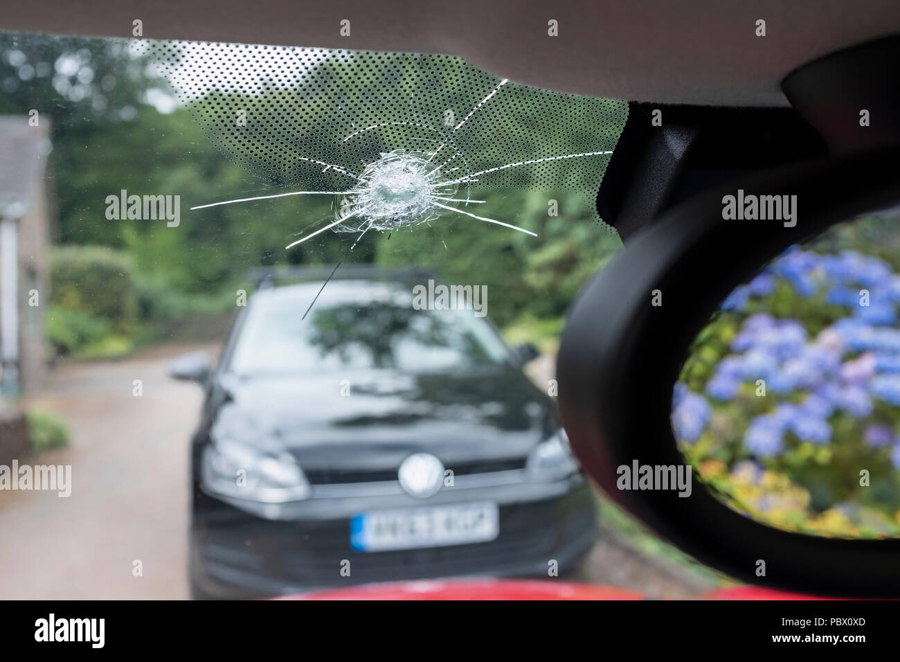Cracked windscreen caused by a stone Stock Photo - Alamy