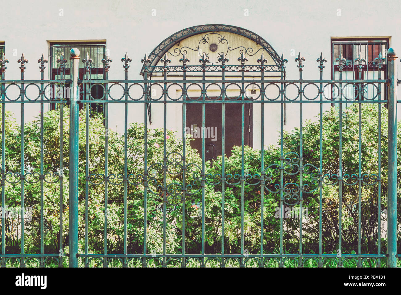 Generic urban city apartment building exterior with green bushes on ...
