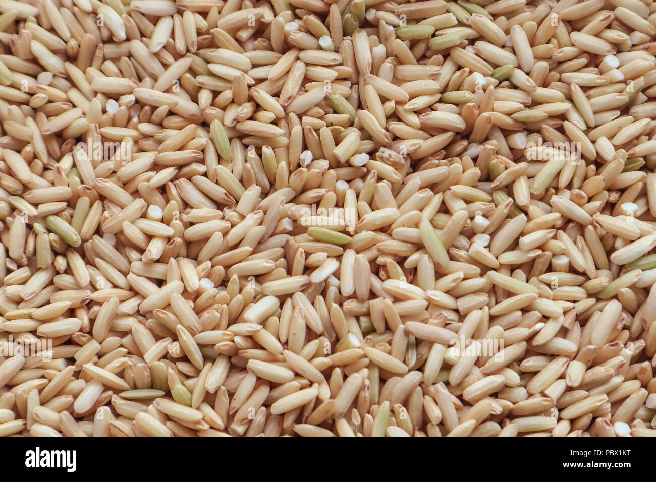 Raw brown rice. top view food background texture Stock Photo - Alamy