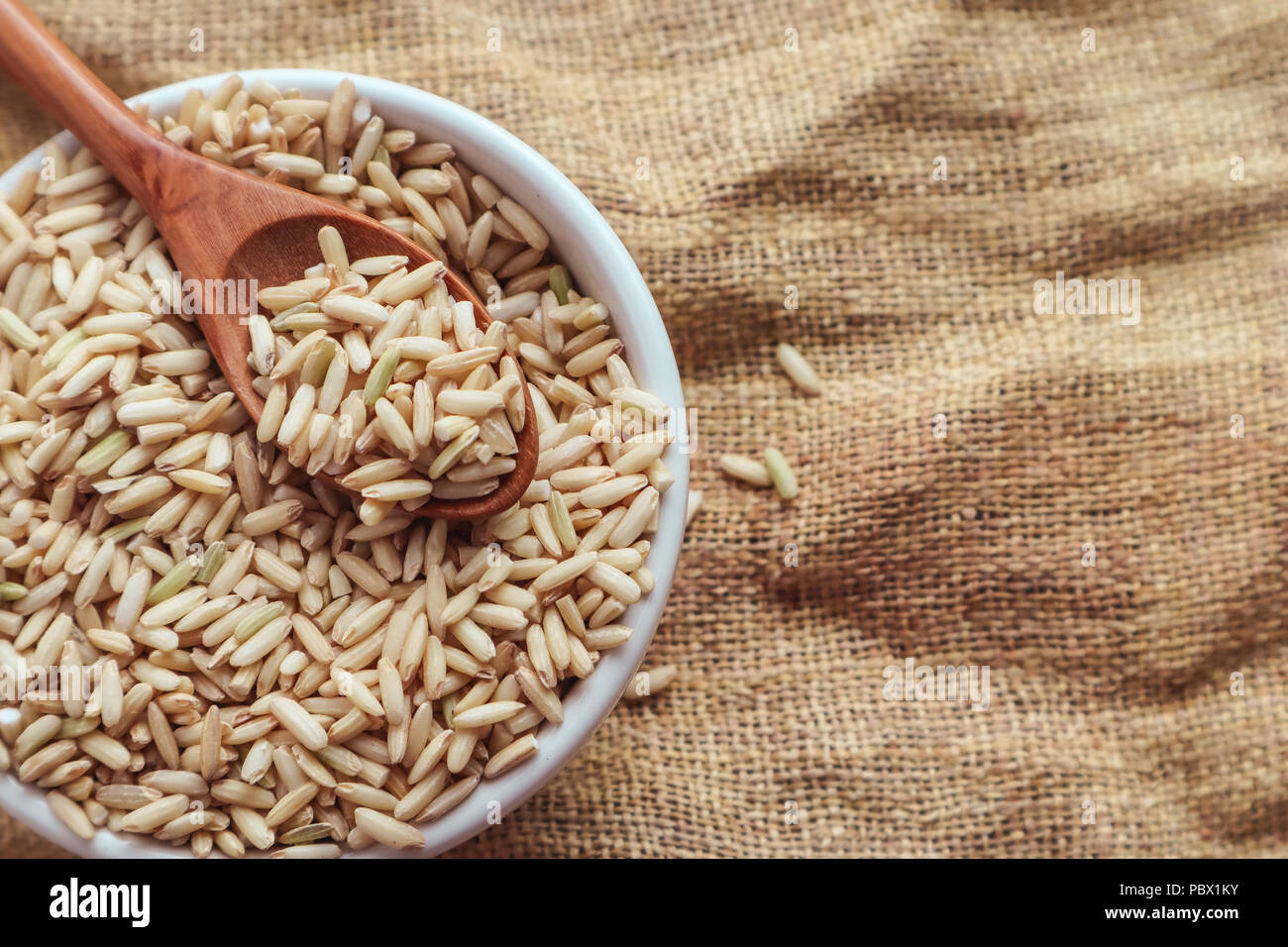 Raw brown rice in a spoon and bowl. top view food background Stock ...