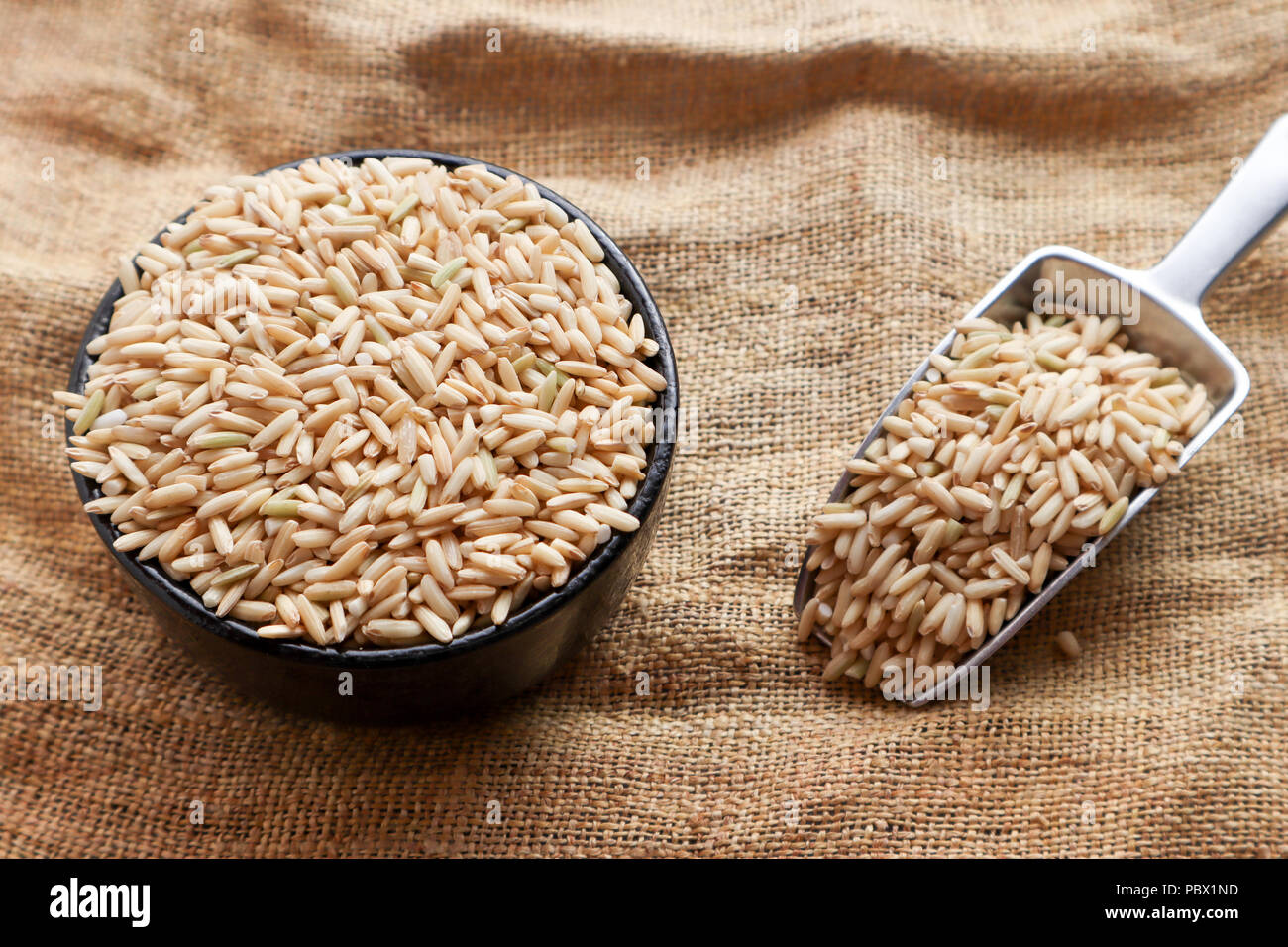 Raw brown rice in a spoon and bowl. top view food background Stock ...