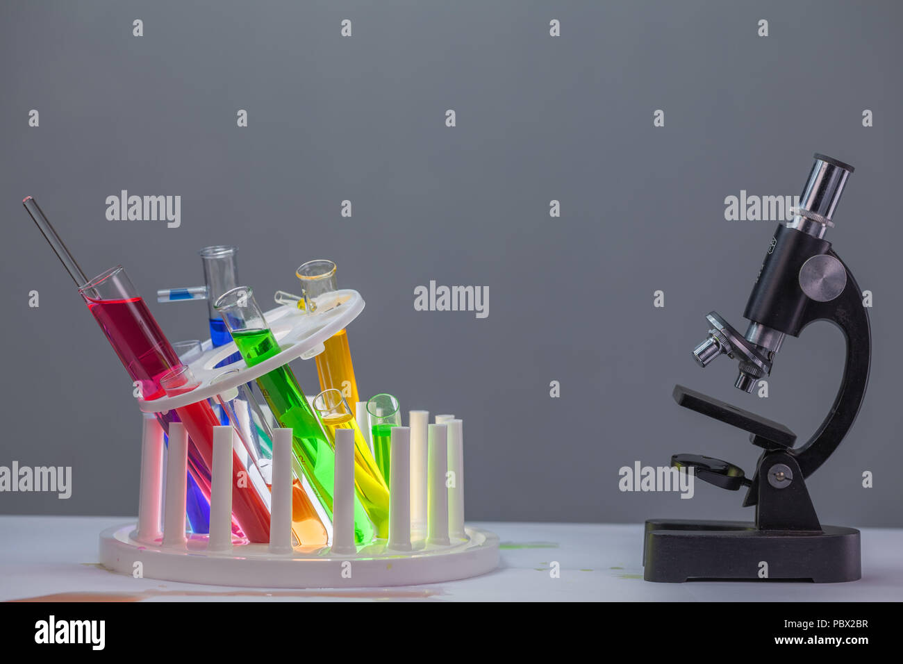 Microscope with chemical experiment tube In the science lab with grey ...