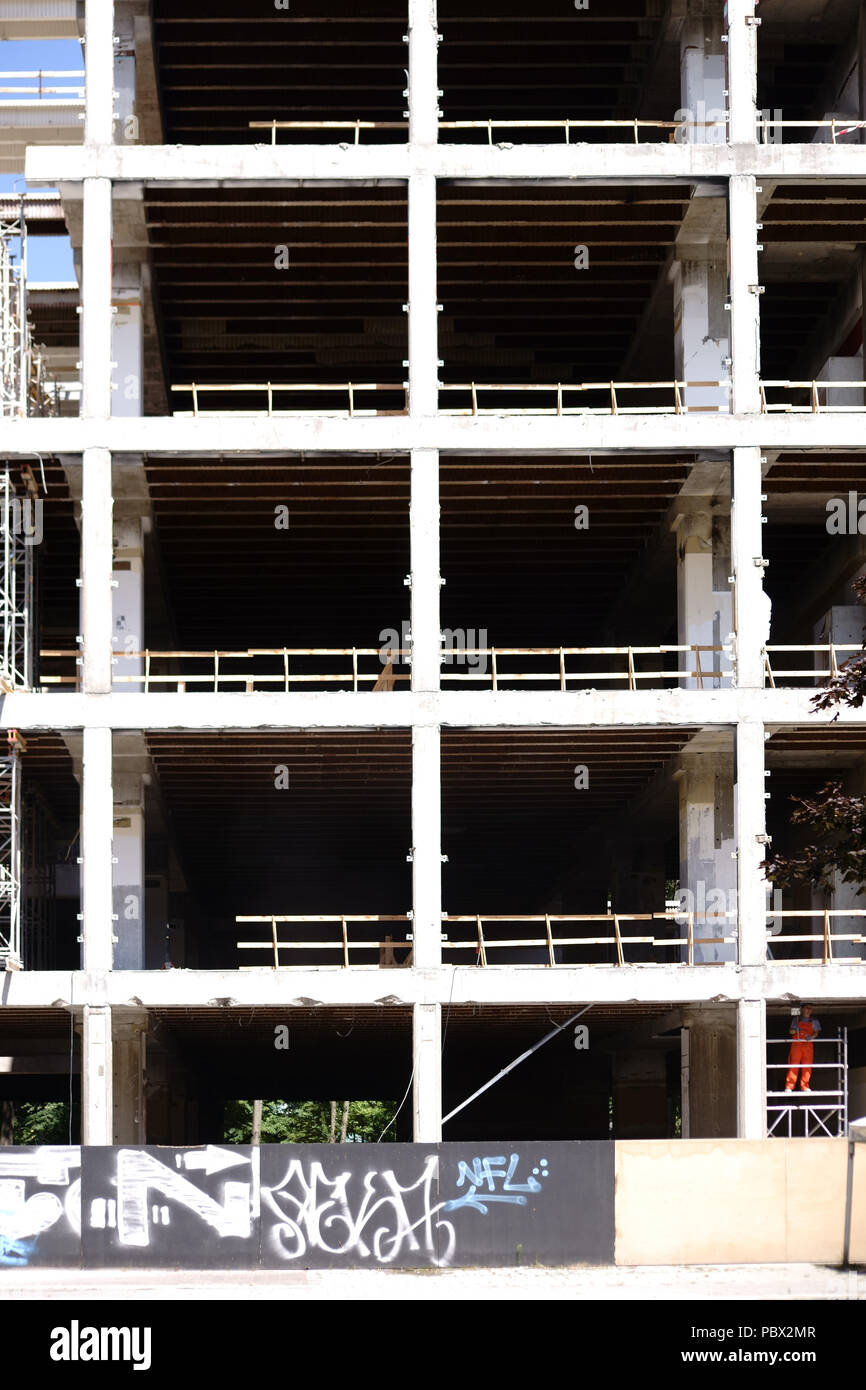 The concrete shell of a building with several floors and false ceilings ...