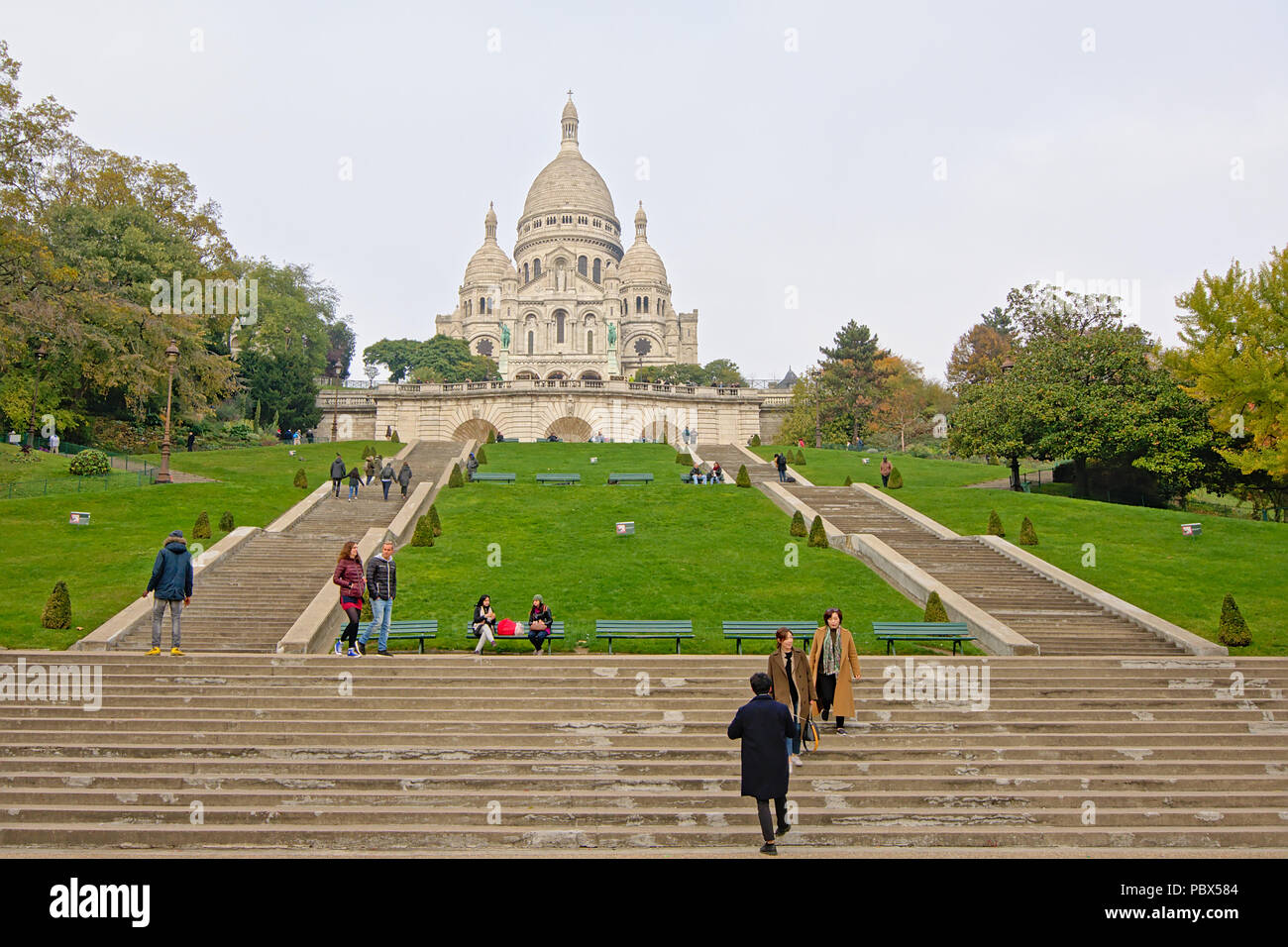 Tourists on the steps leading up to the Basilica of the Sacred Heart or ...