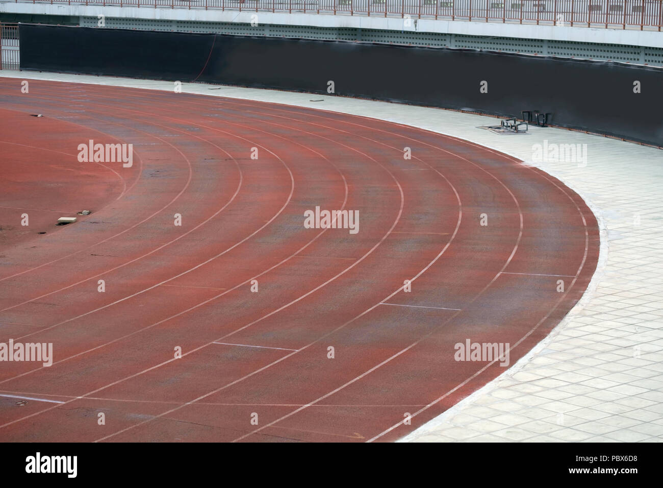 View of red running track in stadium Stock Photo - Alamy