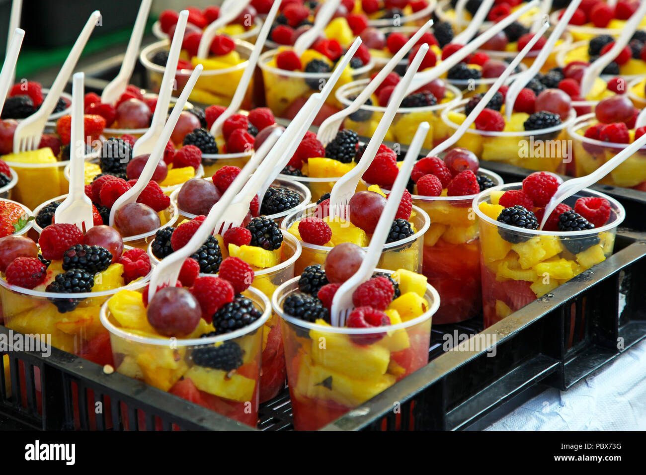 Fruit salad in plastic cups with forks Stock Photo - Alamy