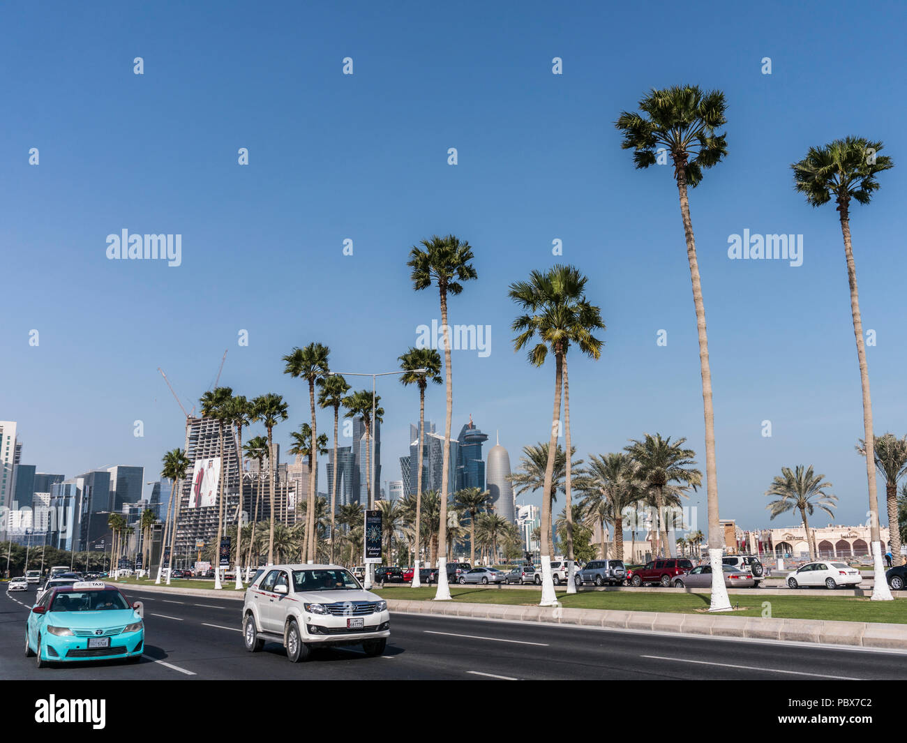 DOHA, QATAR - FEB 2018: Road with Palm Trees Head to Modern Blue High ...