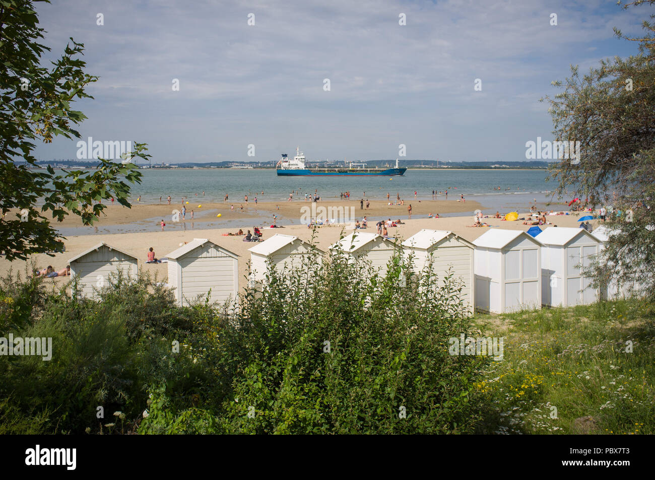 Beach huts on the edge of the sandy beach at the Plage de Butin, as an ...