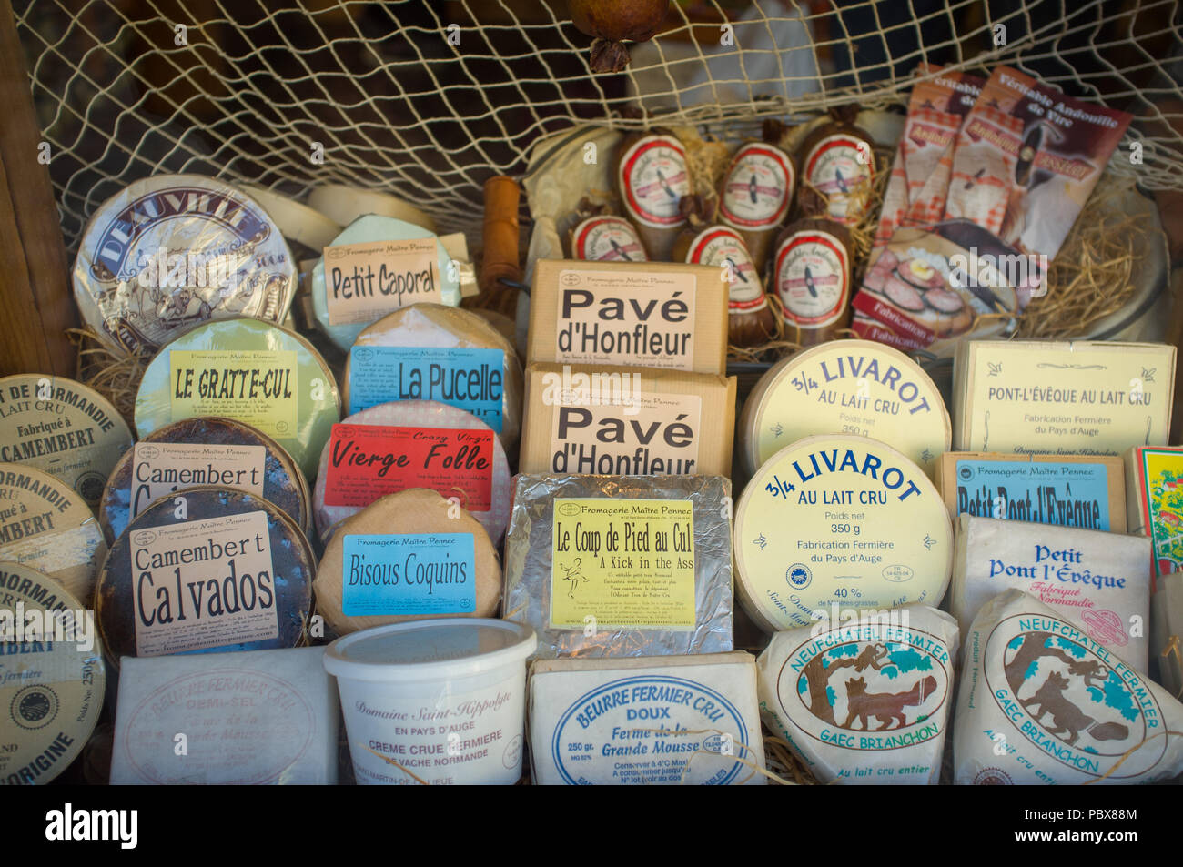 A selection of French cheeses in a shop window, Honfleur, Normandy ...