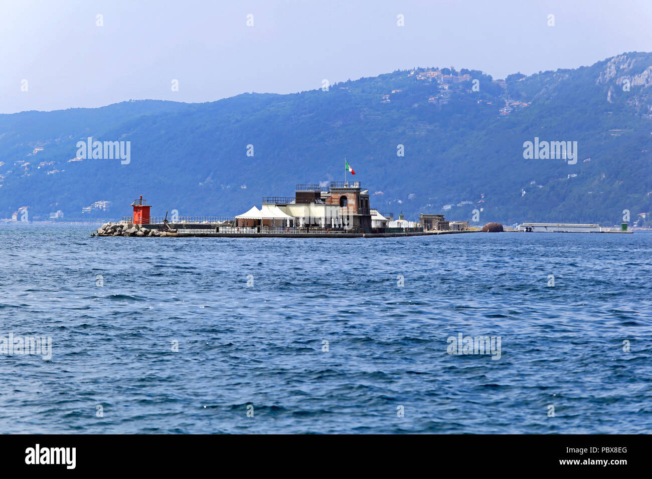Lighthouse and restaurant at breakwater Molo Foraneo in Trieste port ...