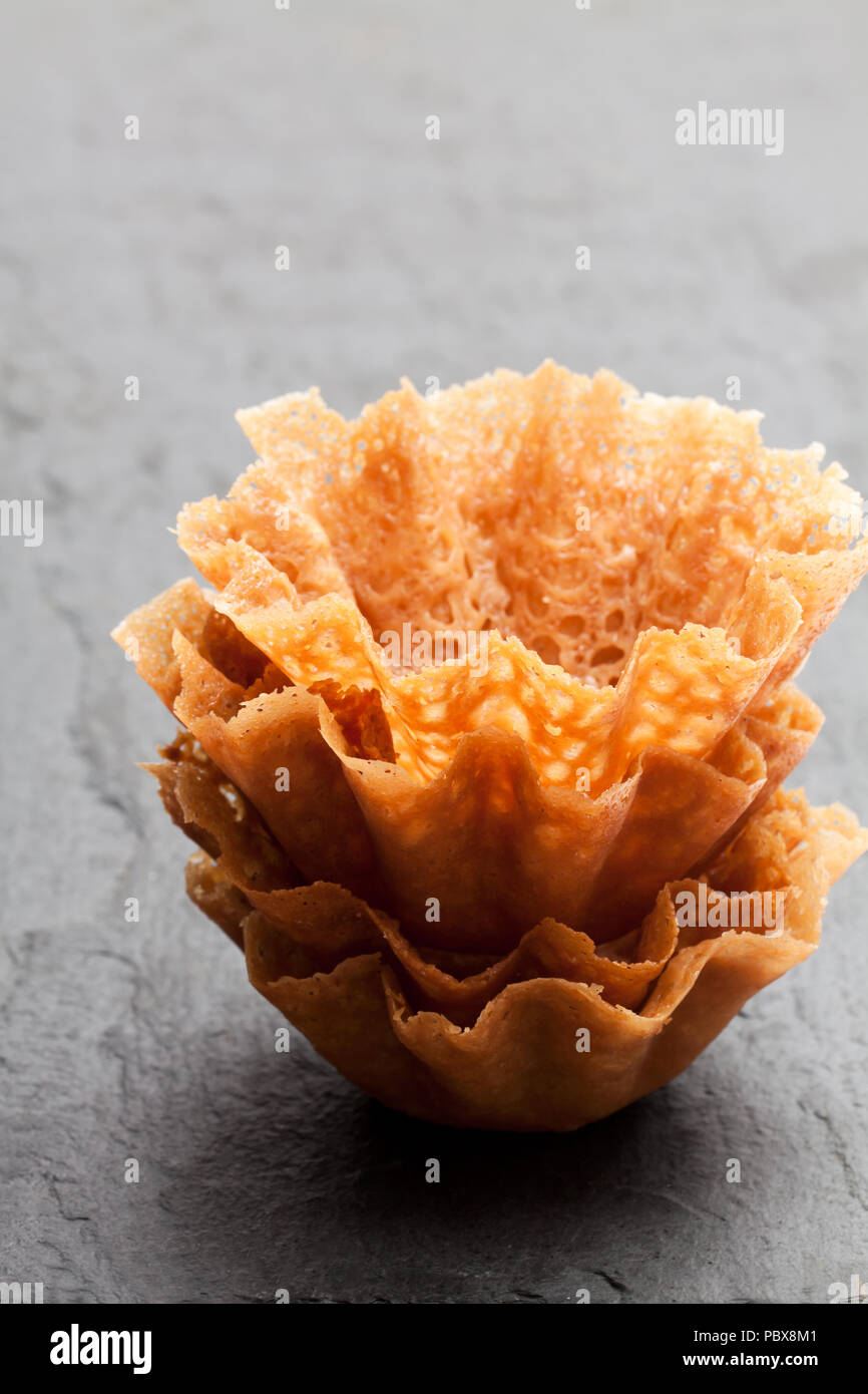 Brandy snap baskets on black stone background Stock Photo - Alamy