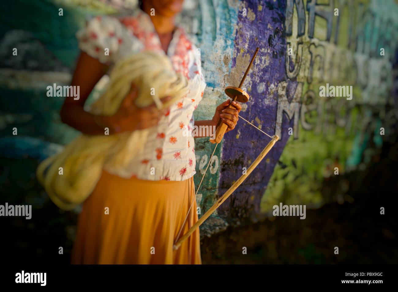 Kankuamo indigenous woman holding the carrumba knitting tool and the ...