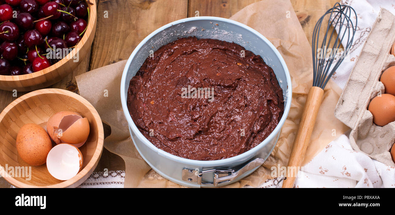 Preparation of a chocolate cake with a cherry. Traditional American ...