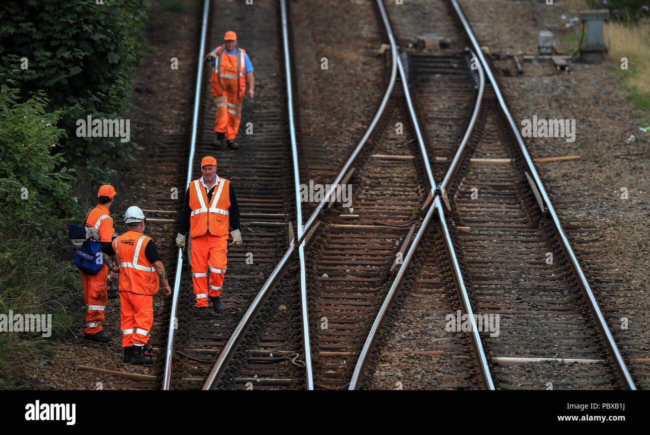 Network Rail staff tend to the line near Hunts Cross Station in ...