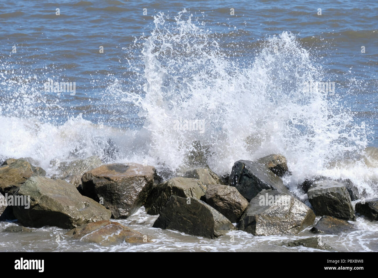 Concept close up images of waves washing over rocks and splashing up ...