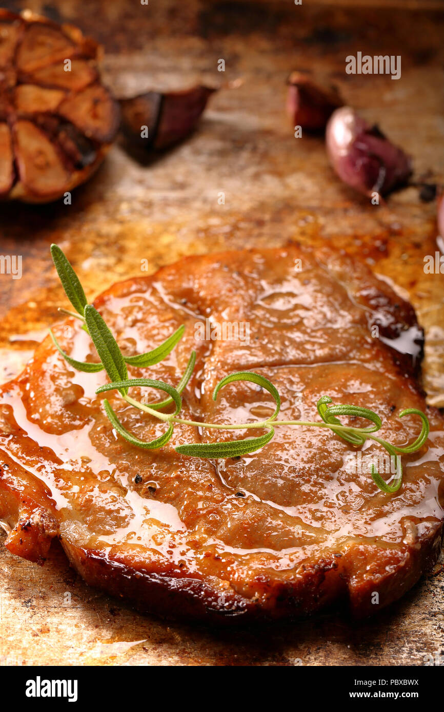 Fried grilled pork neck with garlic on rustic background Stock Photo ...