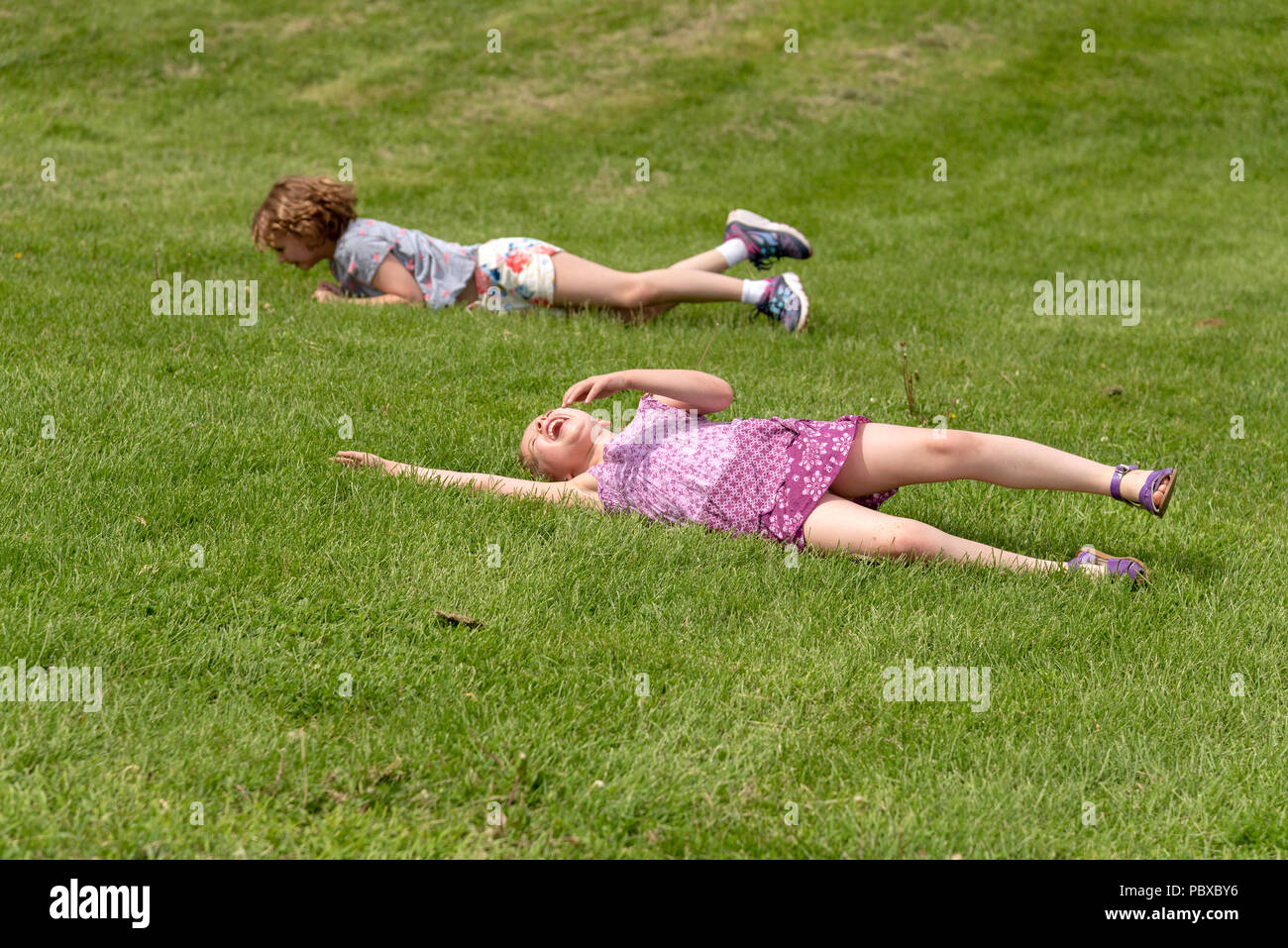 Girls rolling down hill hi-res stock photography and images - Alamy