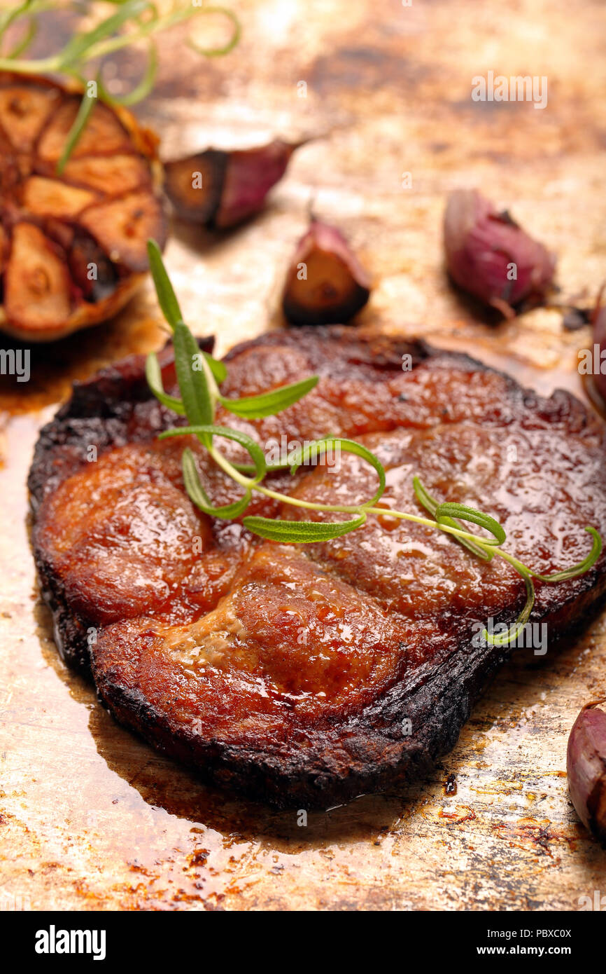 Fried grilled pork neck with garlic on rustic background Stock Photo ...