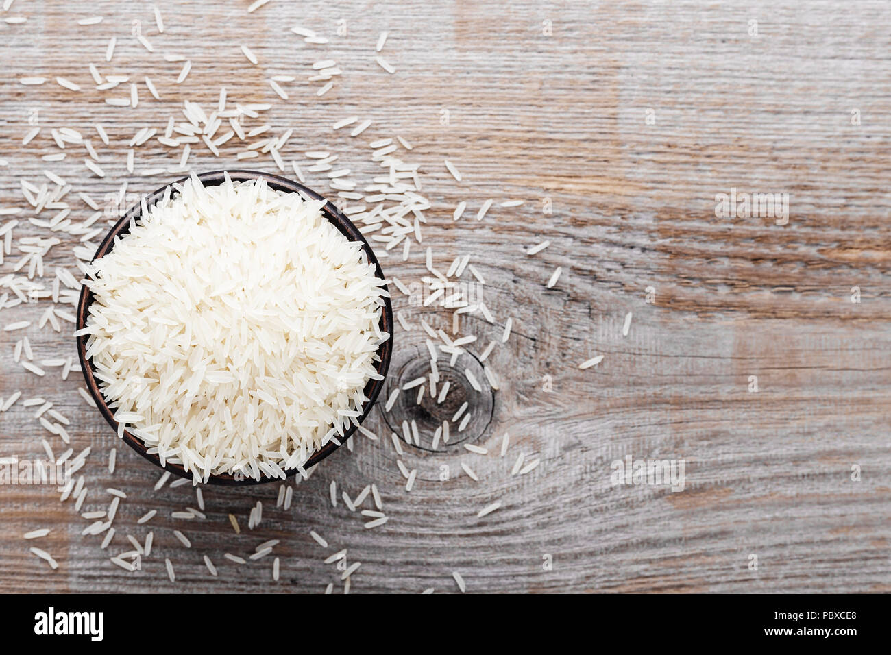 Japanese traditional food, uncooked rice in a bowl on a wooden ...