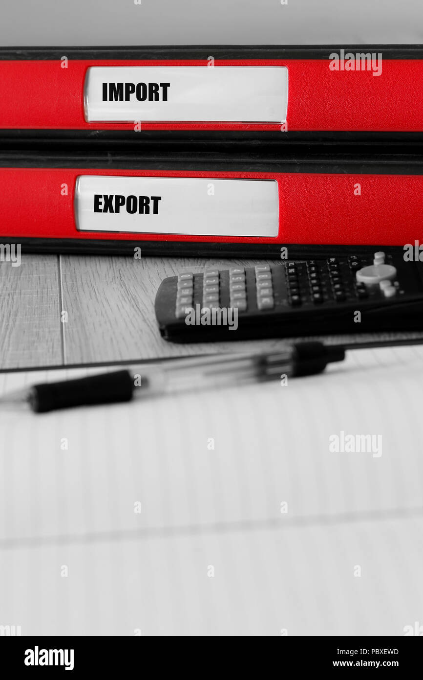 Red folders with import and export written on the label on a desk with ...