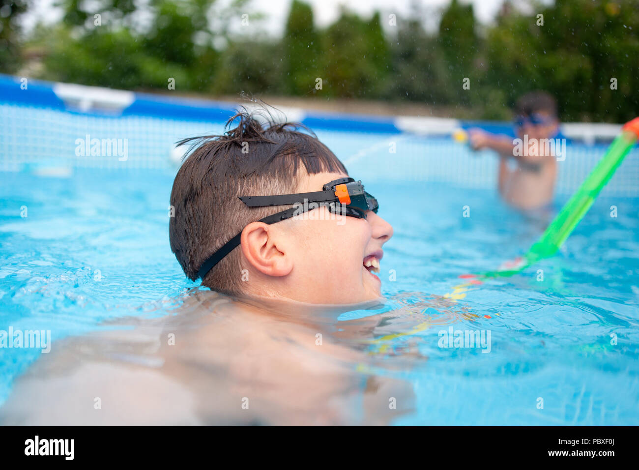Boy shooting water gun hi-res stock photography and images - Alamy