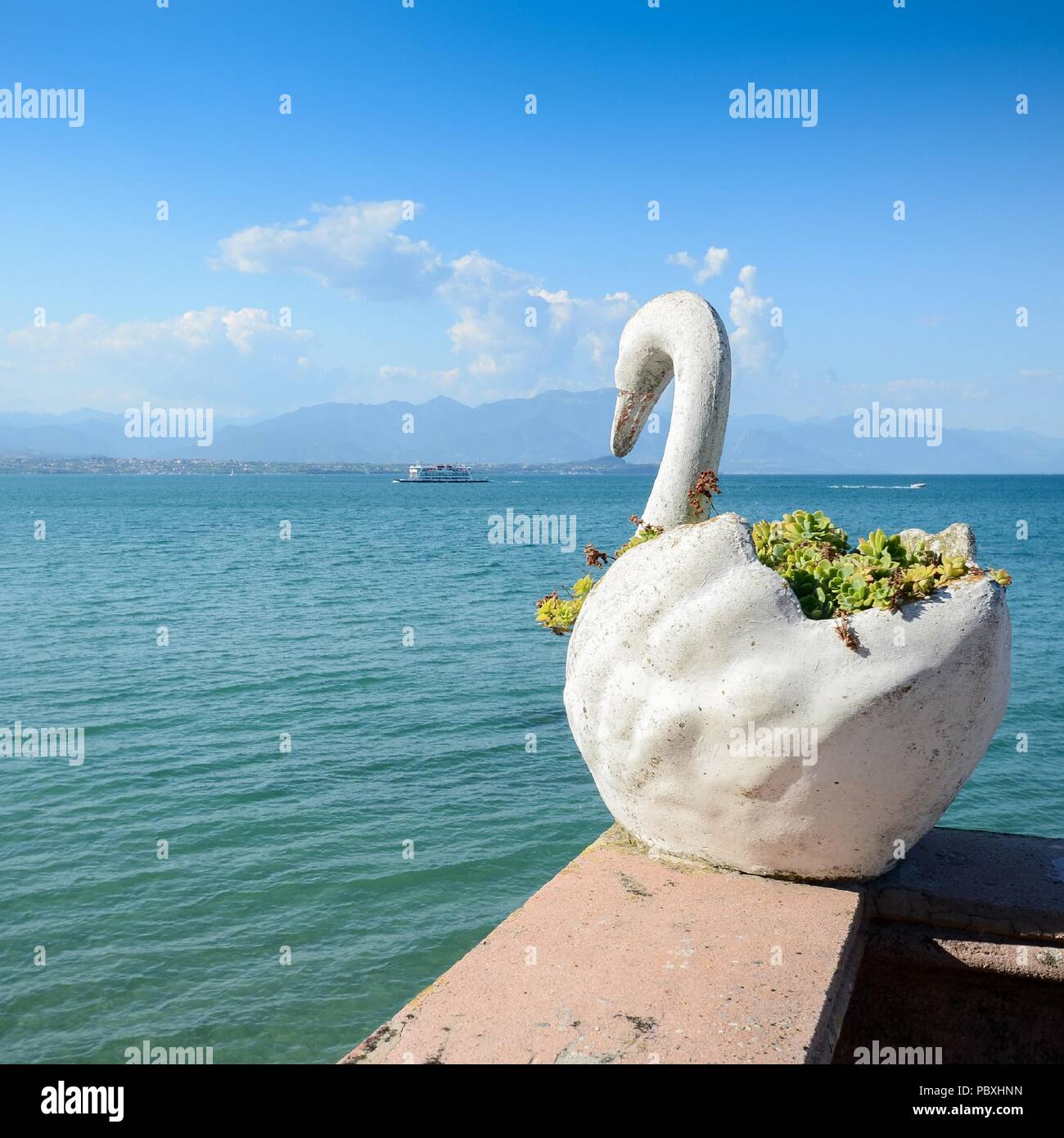 Ornamental swan statue overlooking Garda Lake, Italy Stock Photo - Alamy
