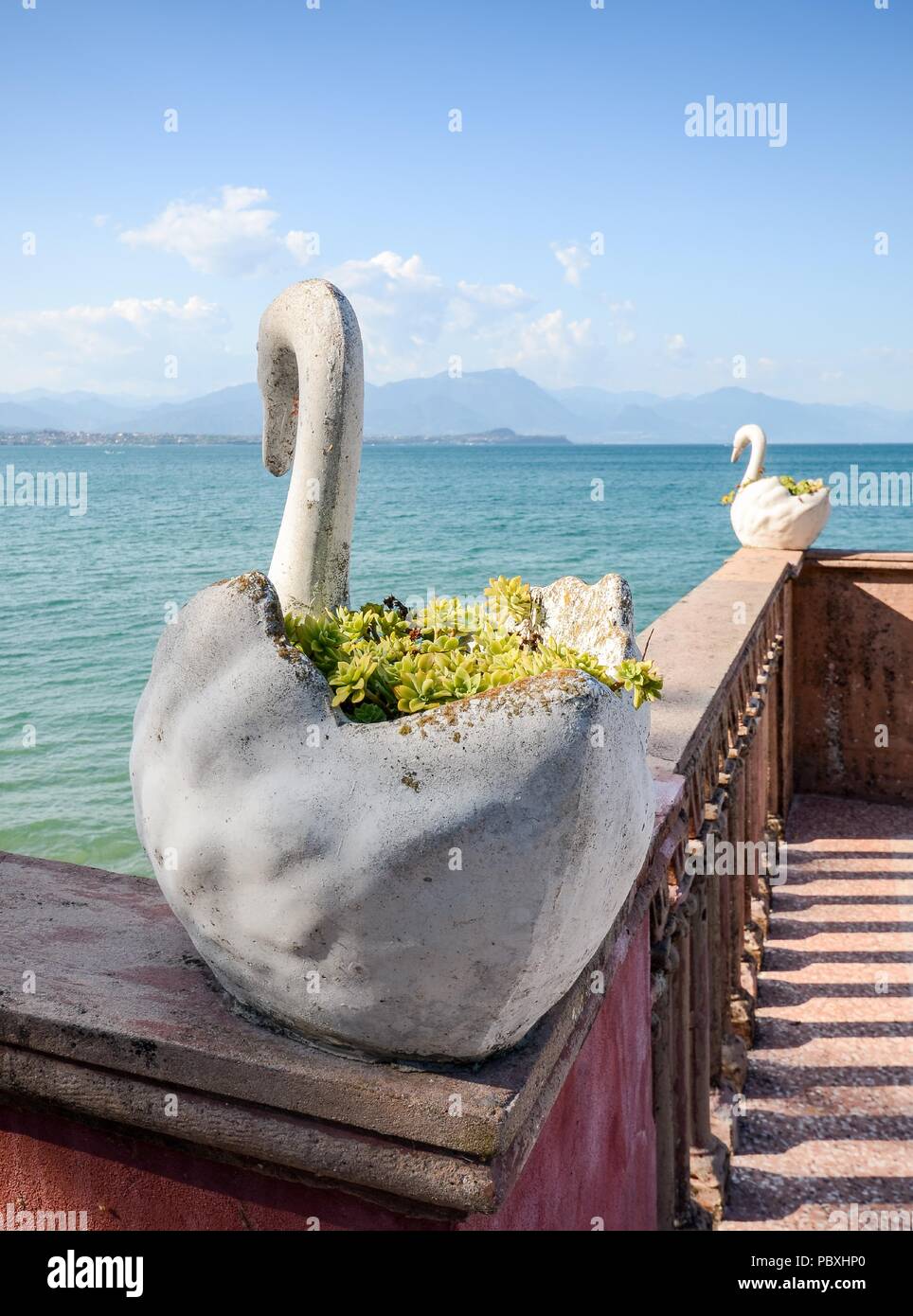 Ornamental swan statue overlooking Garda Lake, Italy Stock Photo - Alamy
