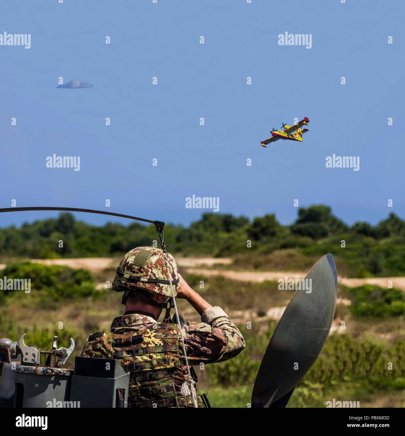 a military on the tank looking at the airplane with binoculars Stock ...