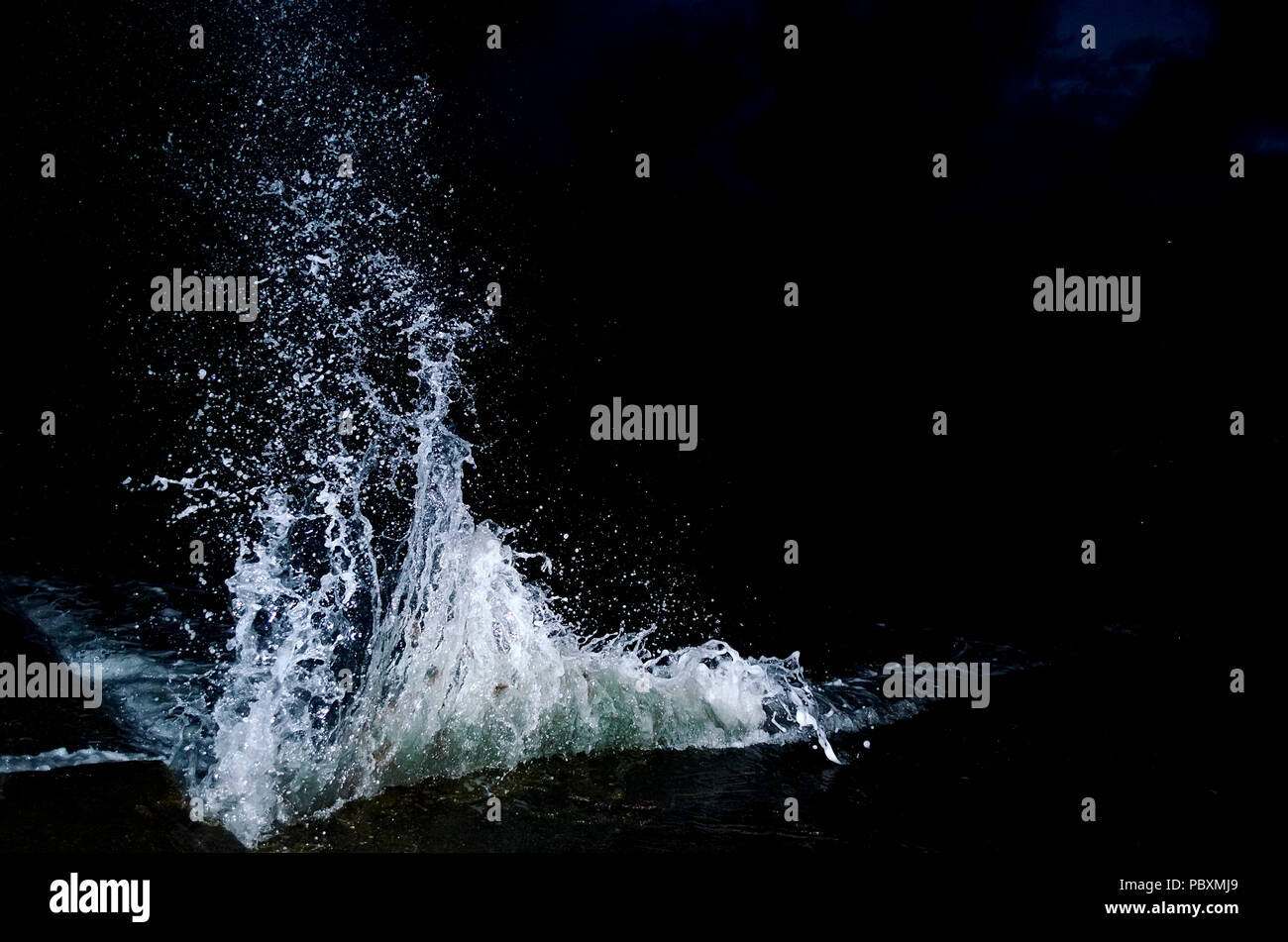 Splashing wave on the Black sea in the night Stock Photo - Alamy