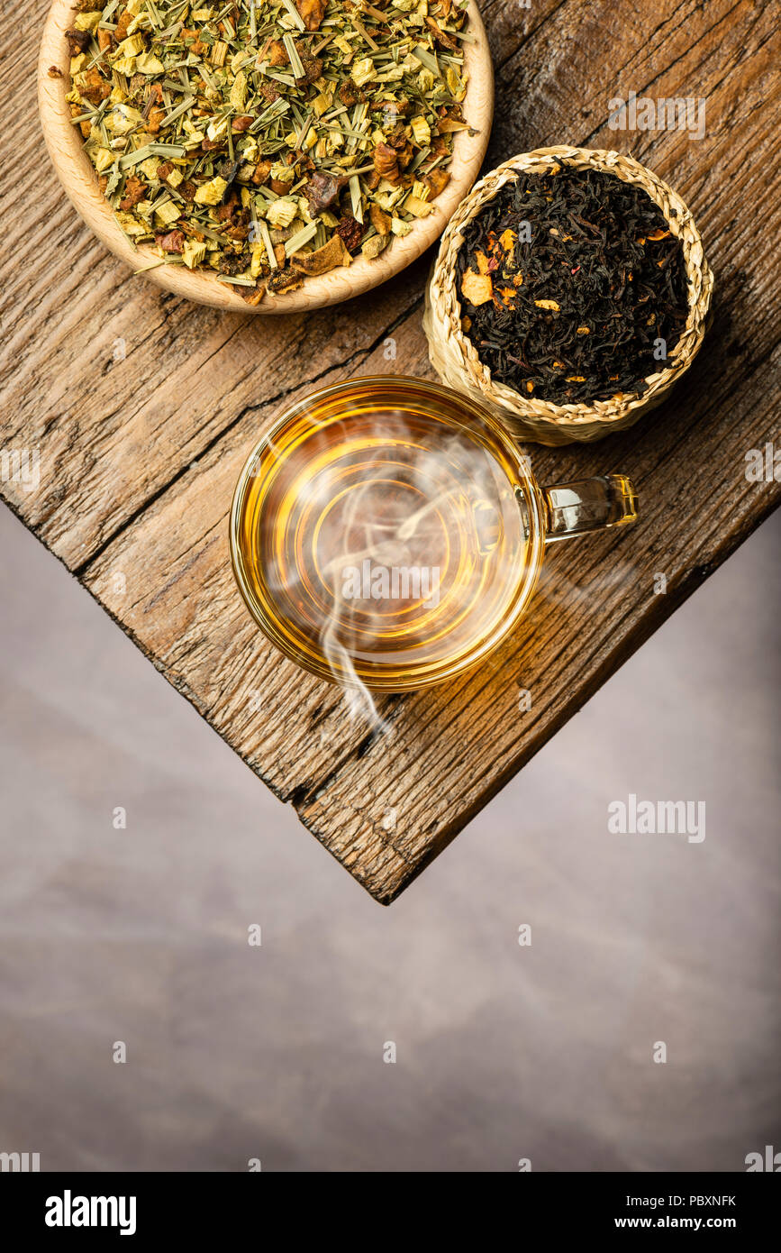 top view steamed glass cup of tea with herbal on wooden table Stock ...