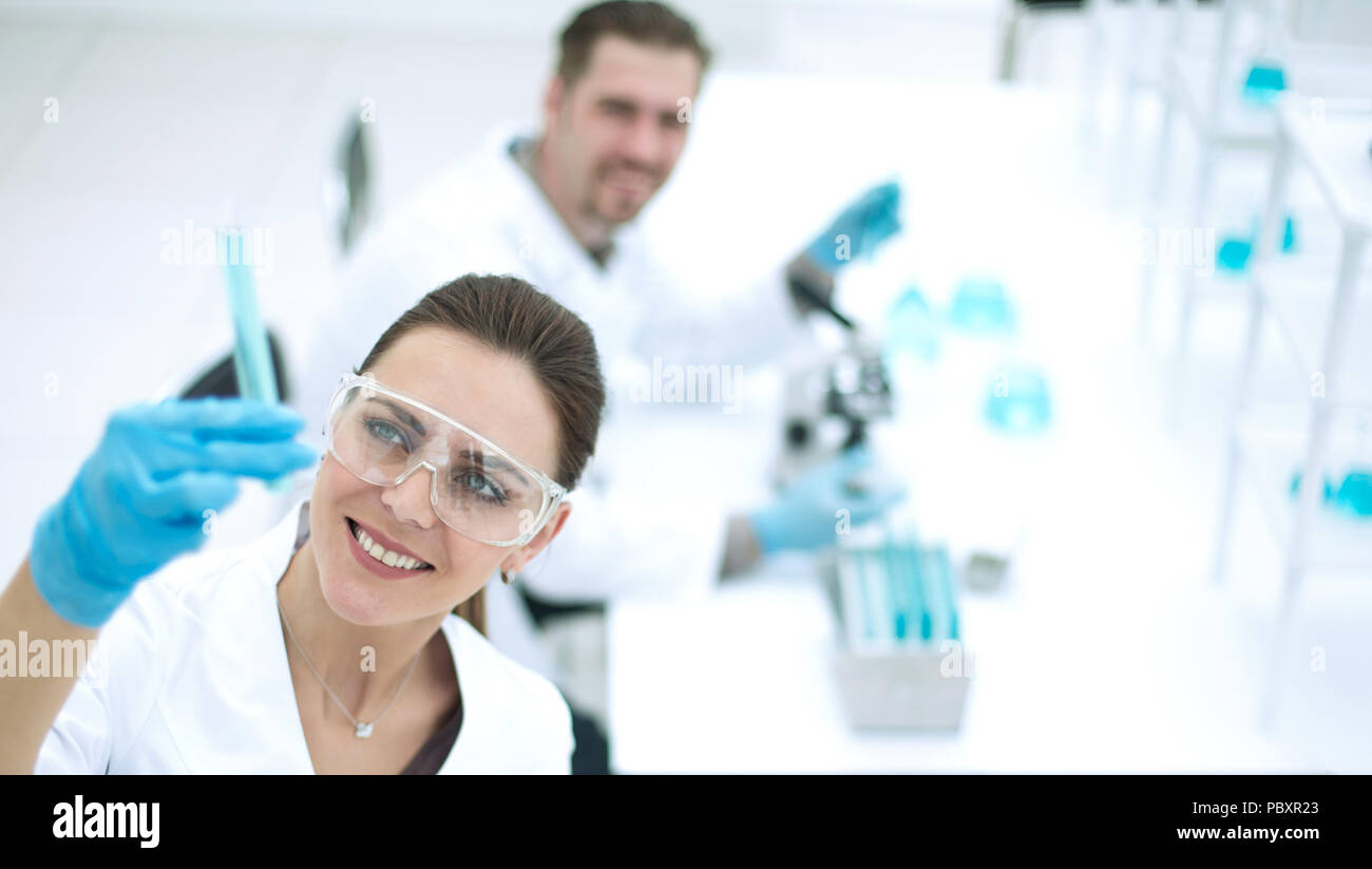 smiling scientist looking at the test results Stock Photo - Alamy