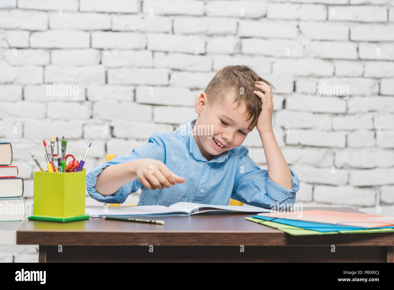 Young boy learning for school Stock Photo - Alamy